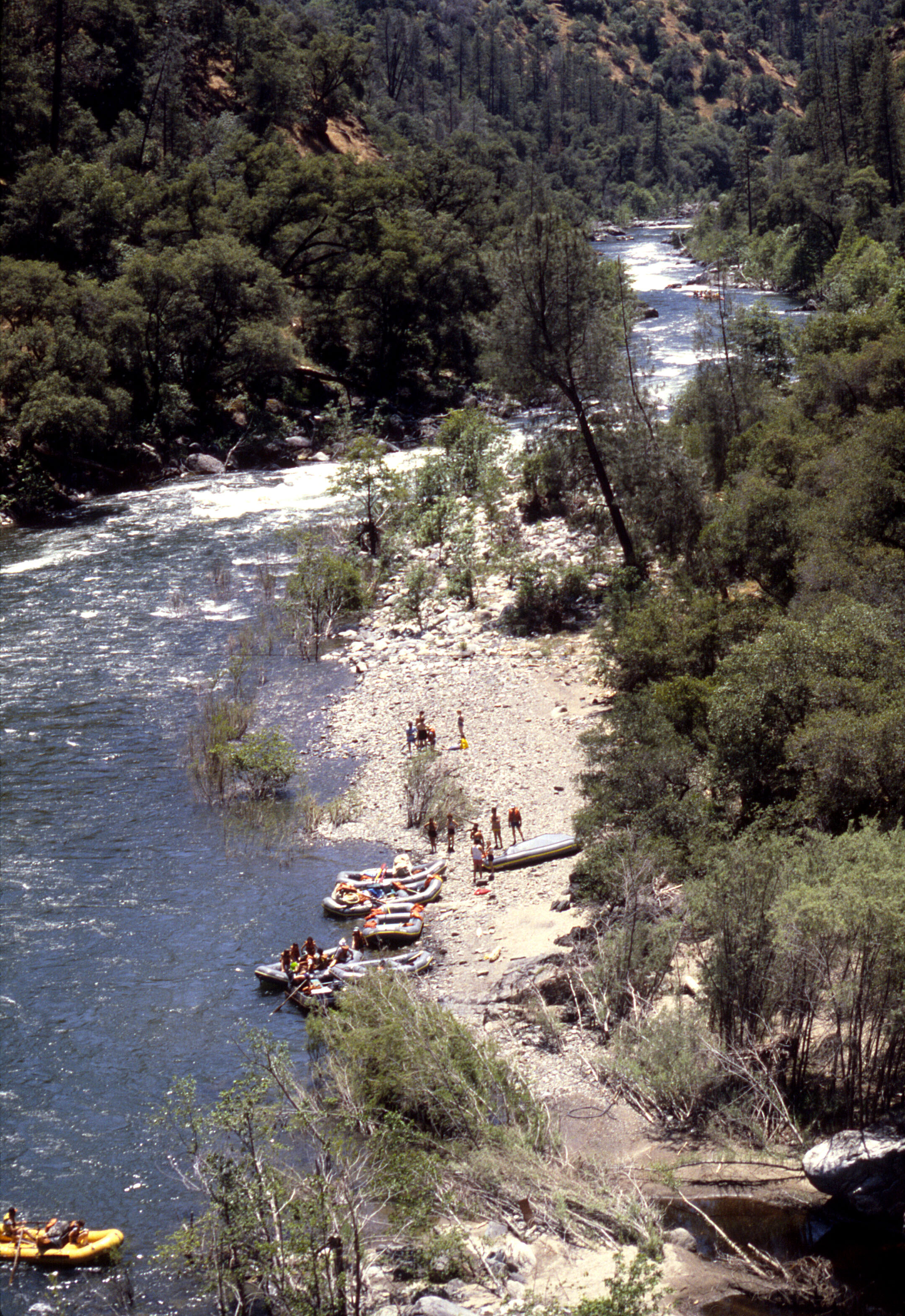 Rafters on shore above Death Rock, repairing a raft SEQ - The ...